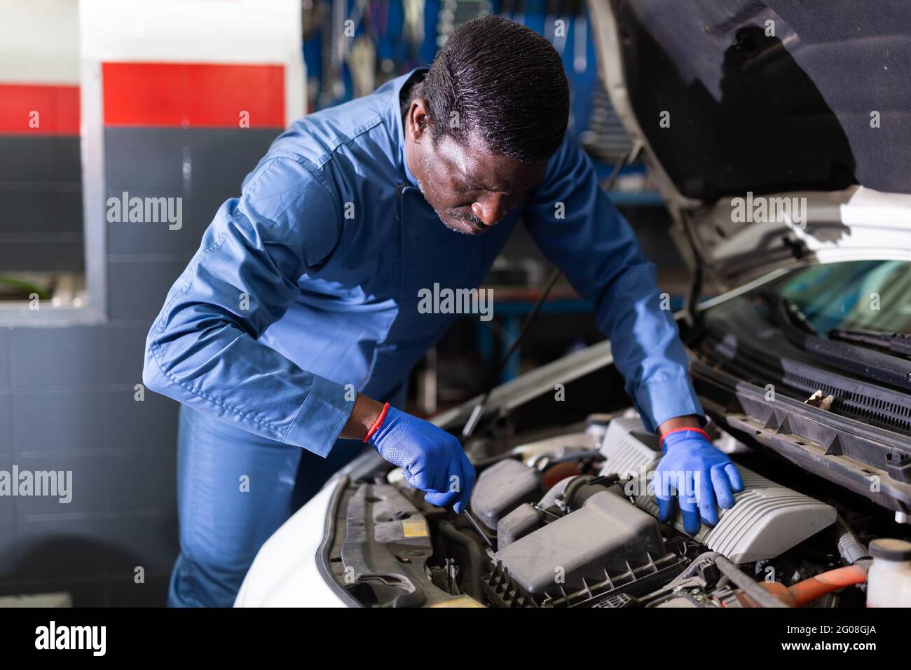 Professional man car mechanician repairing car in auto repair Stock ...
