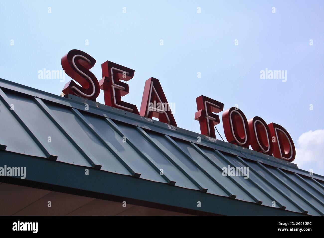 Restaurant Sign on Building Roof Stock Photo - Alamy