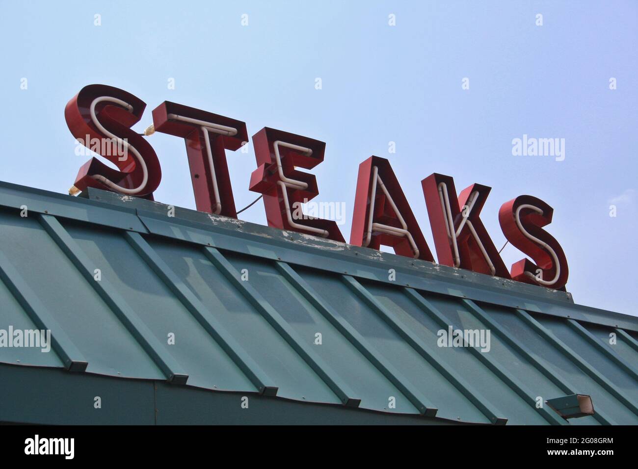Restaurant Sign on Building Roof Stock Photo - Alamy
