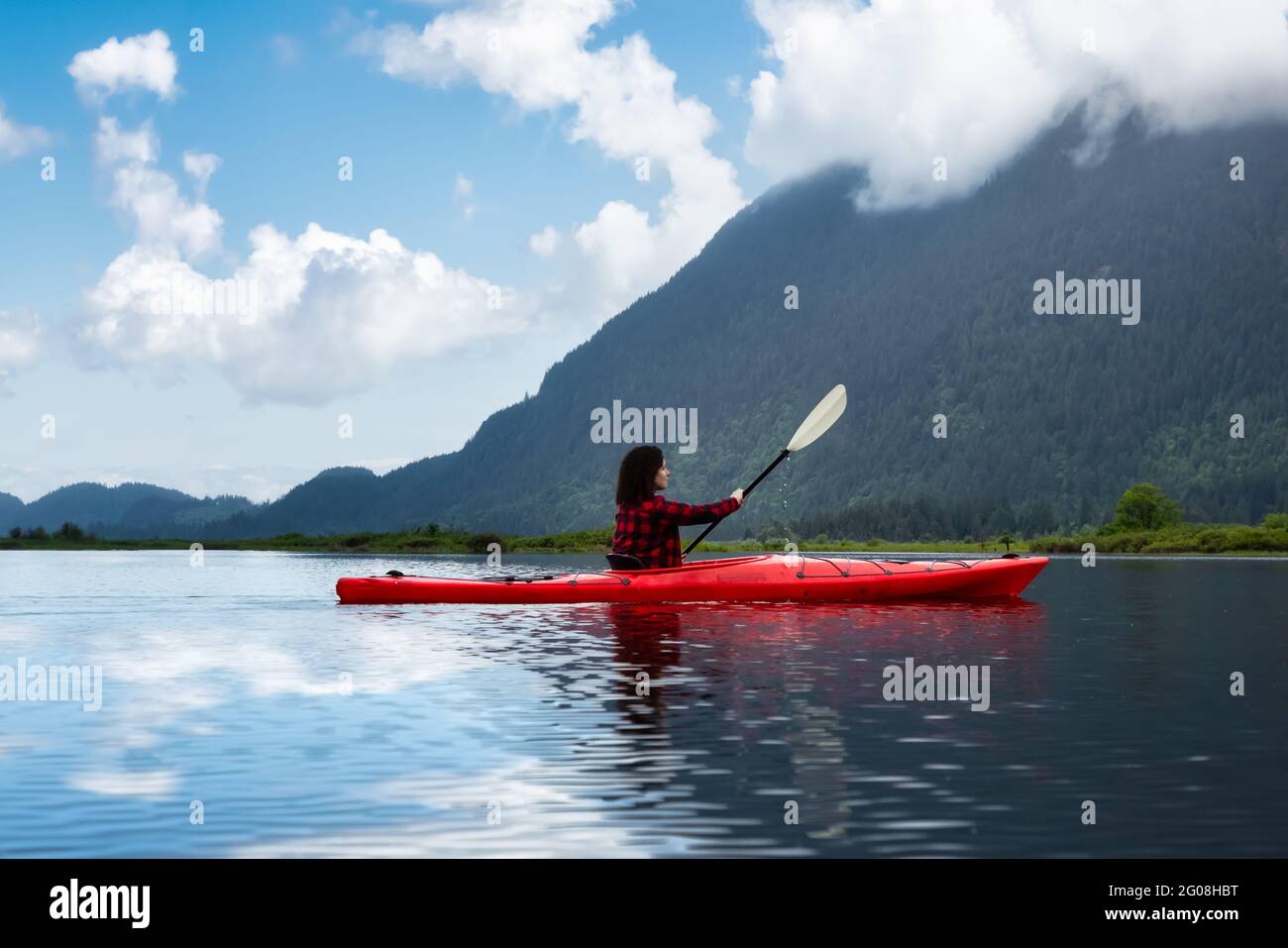 Adventure Caucasian Adult Woman Kayaking in Red Kayak Stock Photo - Alamy