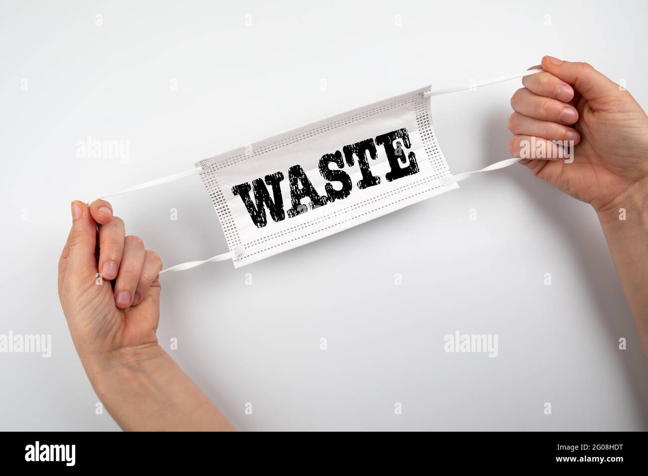 Waste recycling and sorting concept. Medical face mask on a white ...