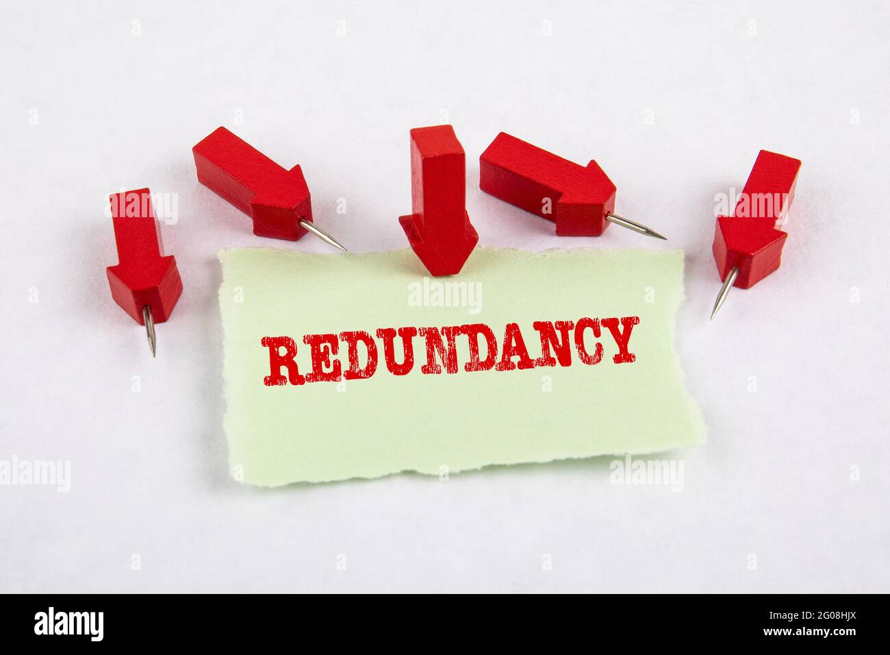 Redundancy. Note sheet and red arrows on white paper background Stock ...