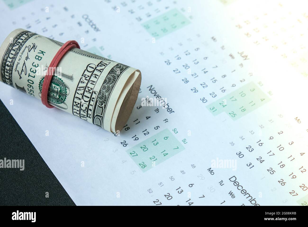 Office workplace desk with dollars and calendar. Counting money for ...