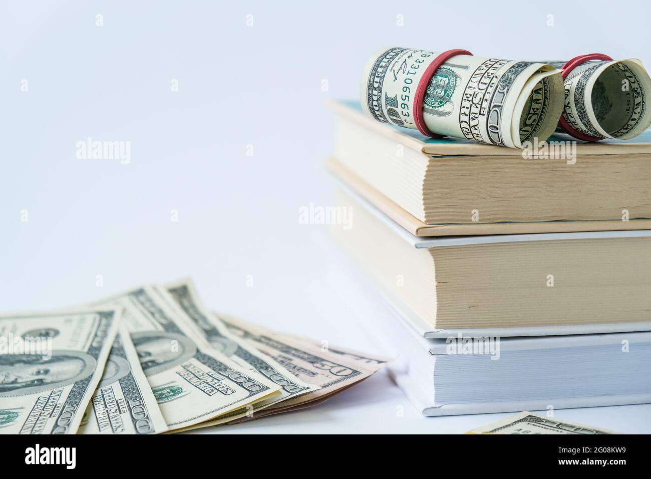 Knowledge leads to wealth. Stack of books with dollars. Concept of ...