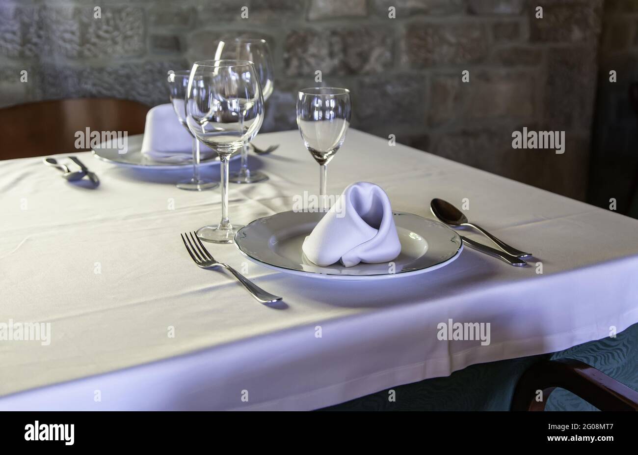 Restaurant table set up with glasses and plates, celebration and event ...