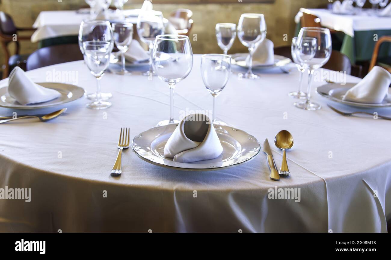 Restaurant table set up with glasses and plates, celebration and event ...