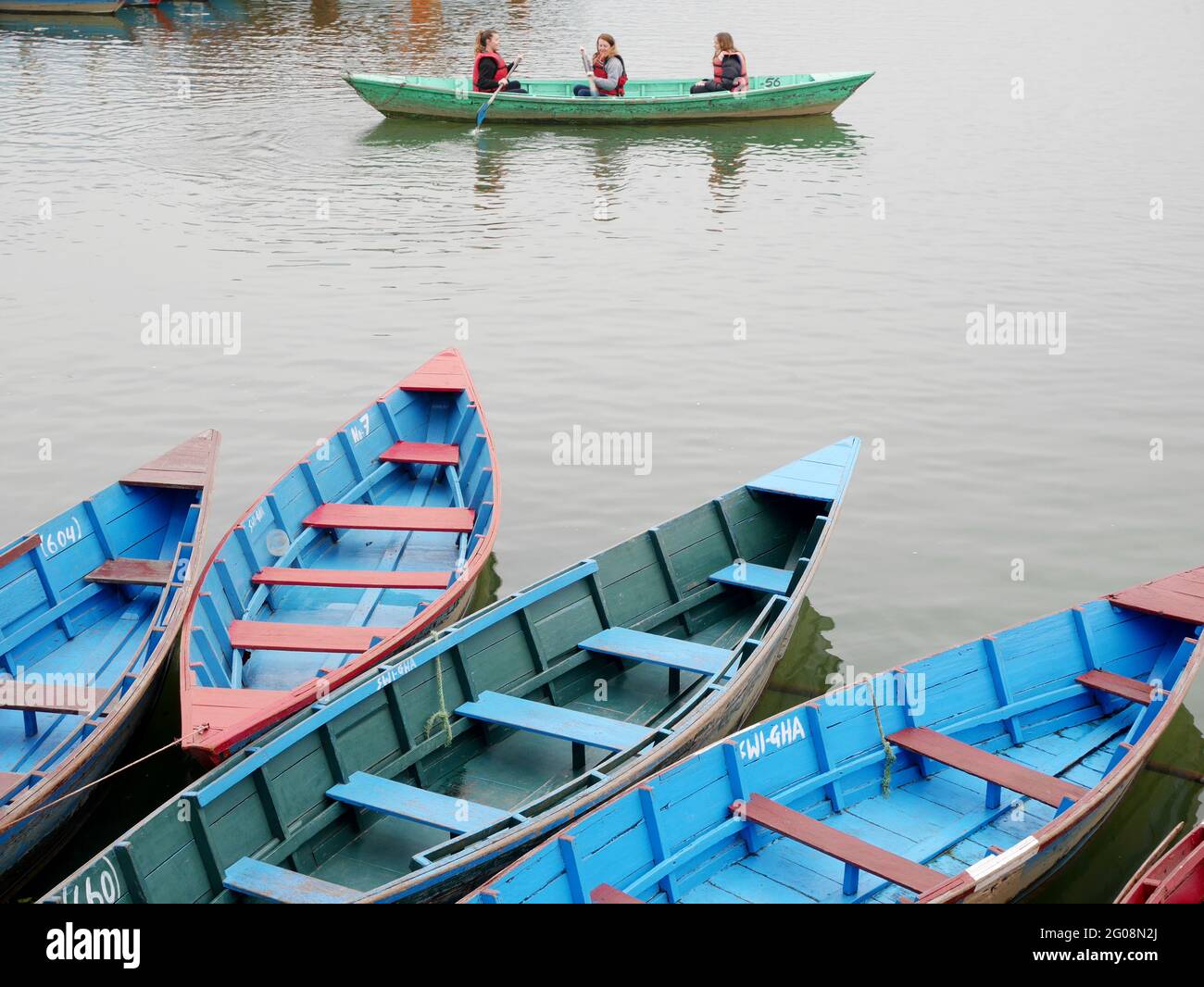 Wooden canoe boat floating in Phewa Tal or Fewa Freshwater Lake wait ...
