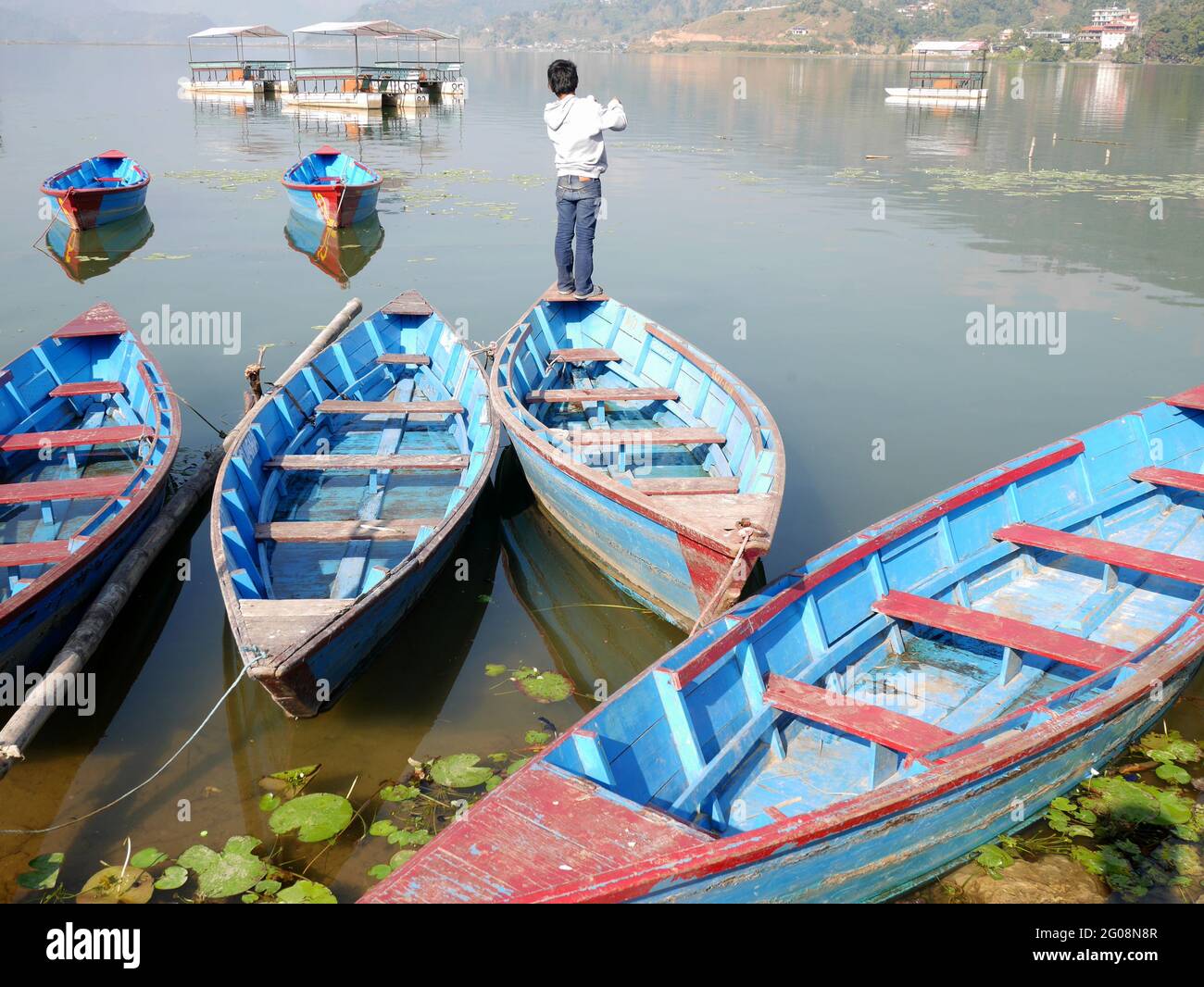 Wooden canoe boat floating in Phewa Tal or Fewa Freshwater Lake wait ...
