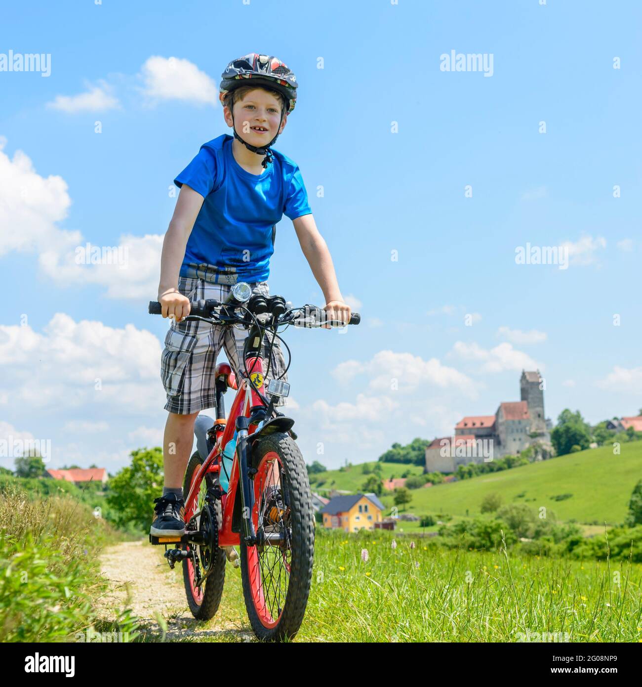 Young boy on the way in nature with his bicycle Stock Photo - Alamy