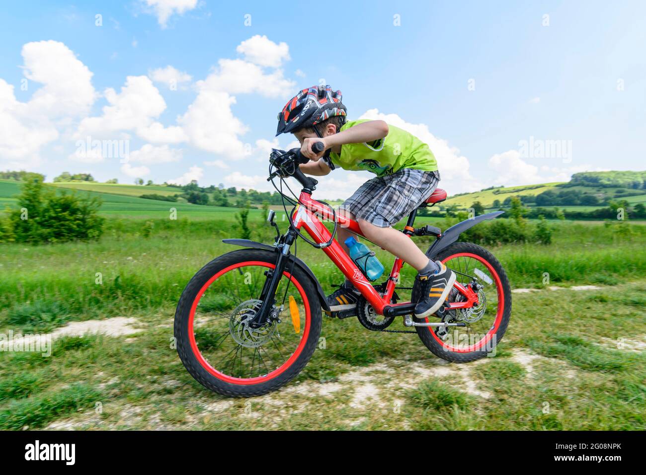 Young boy on the way in nature with his bicycle Stock Photo - Alamy