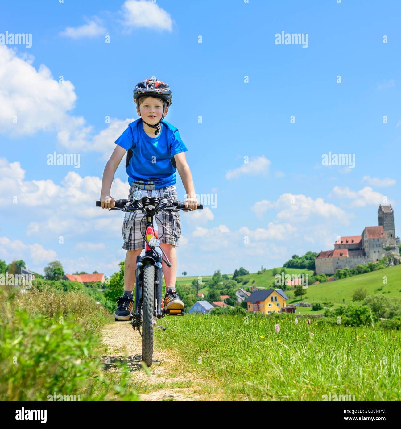 Young boy on the way in nature with his bicycle Stock Photo - Alamy