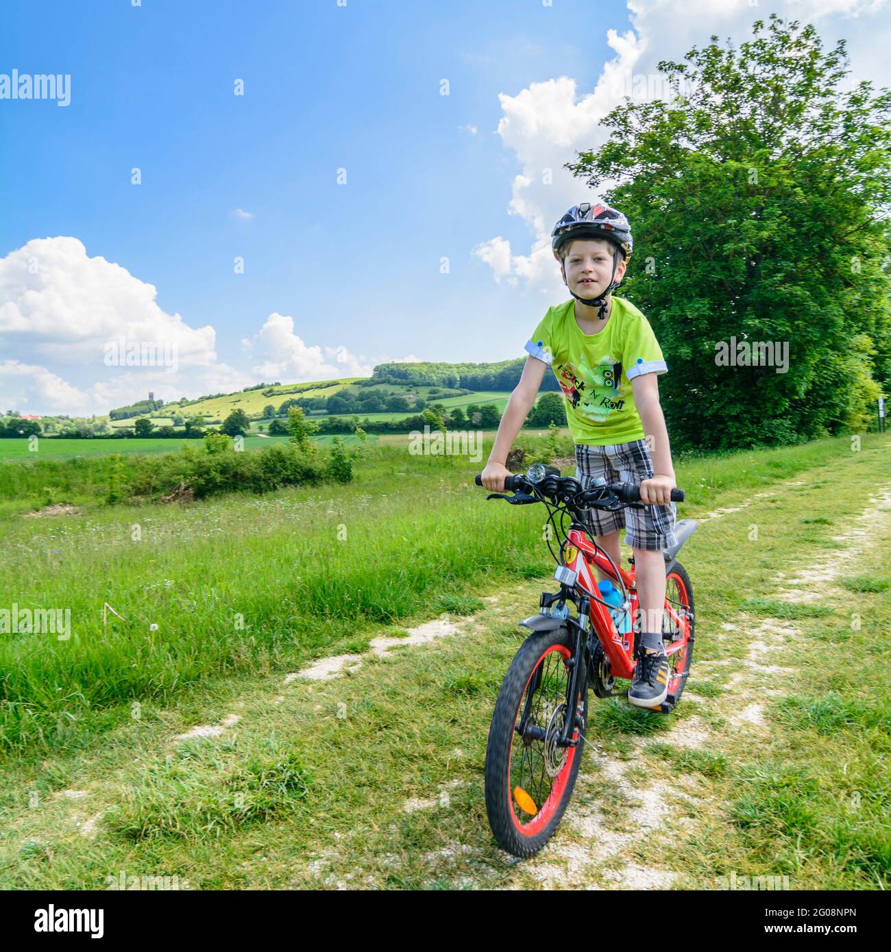 Young boy on the way in nature with his bicycle Stock Photo - Alamy