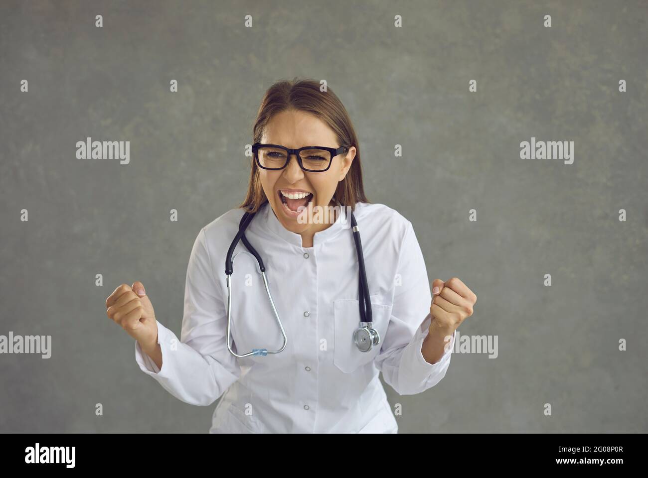 Happy excited young female doctor shouting Yes celebrating her ...