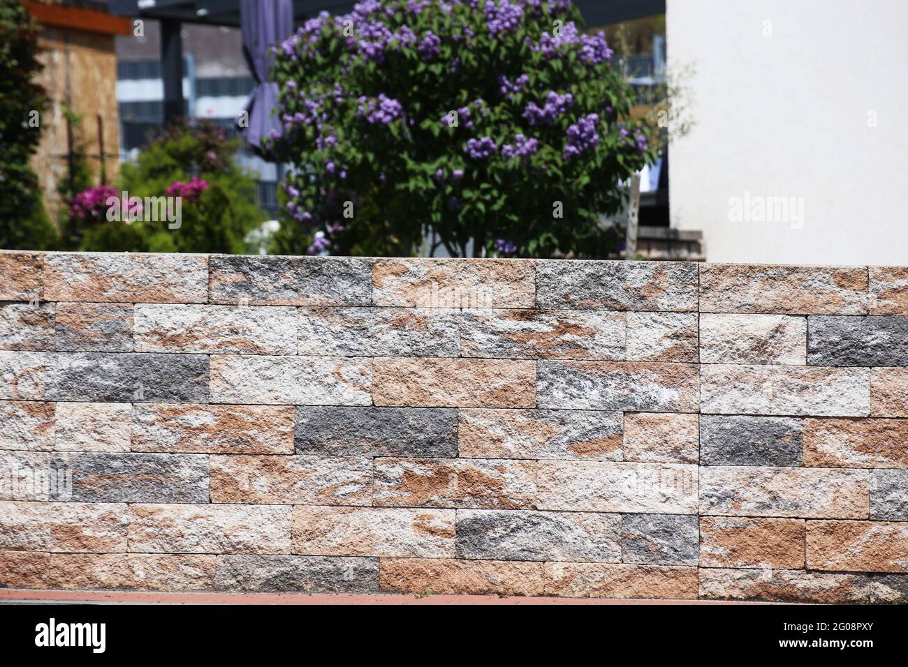 Natural stone wall as a property line and sight protection Stock Photo ...