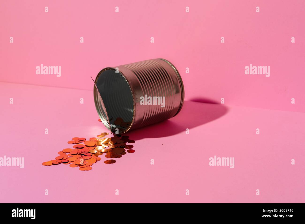 Canned food tin on pink studio background Stock Photo - Alamy