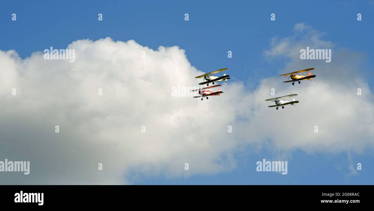 Vintage Tiger Moth Bi Planes Flying in formation blue sky and clouds ...