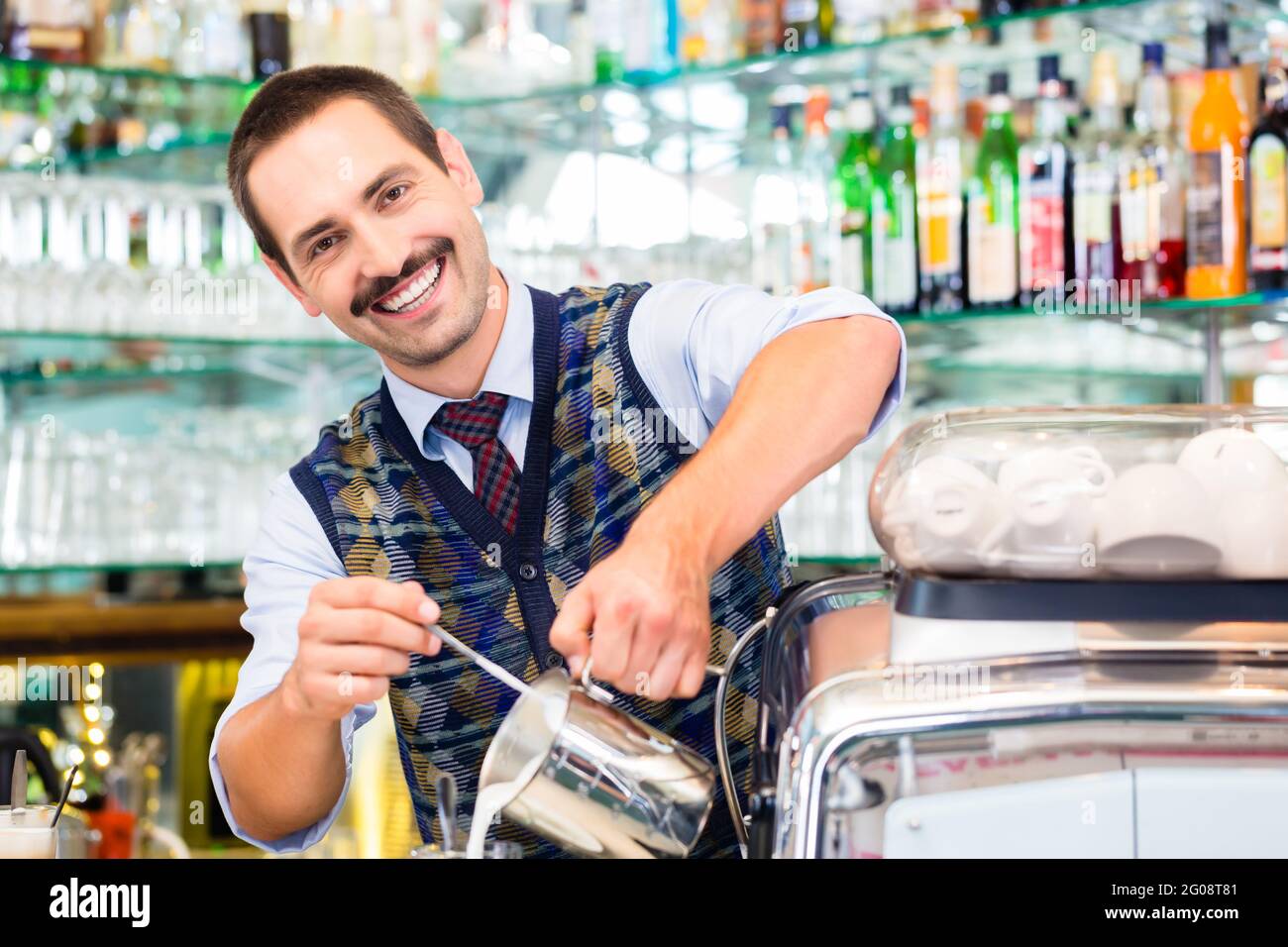 Barista in cafe or coffee bar preparing pouring espresso shot in glass ...