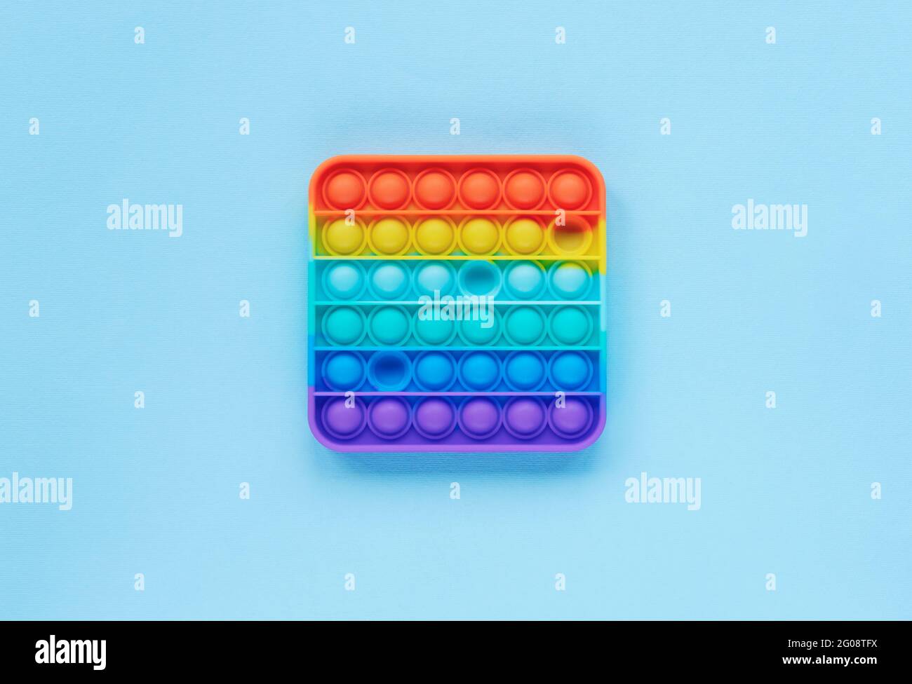 Colorful poppit game on blue background. Pop it fidget toy. Top view ...