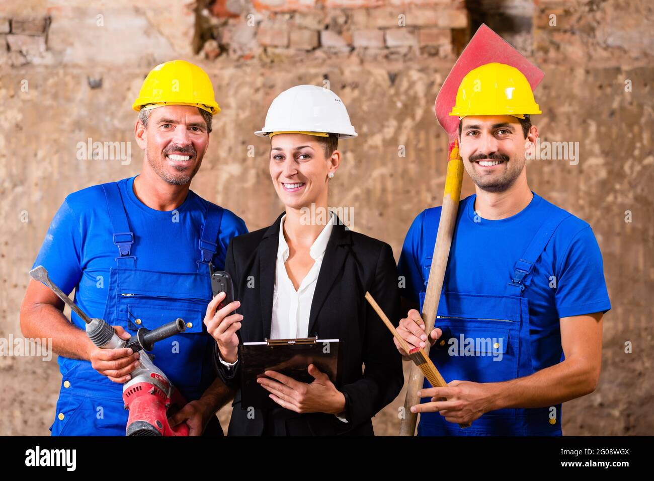 Builders with machines and architect on construction site Stock Photo ...