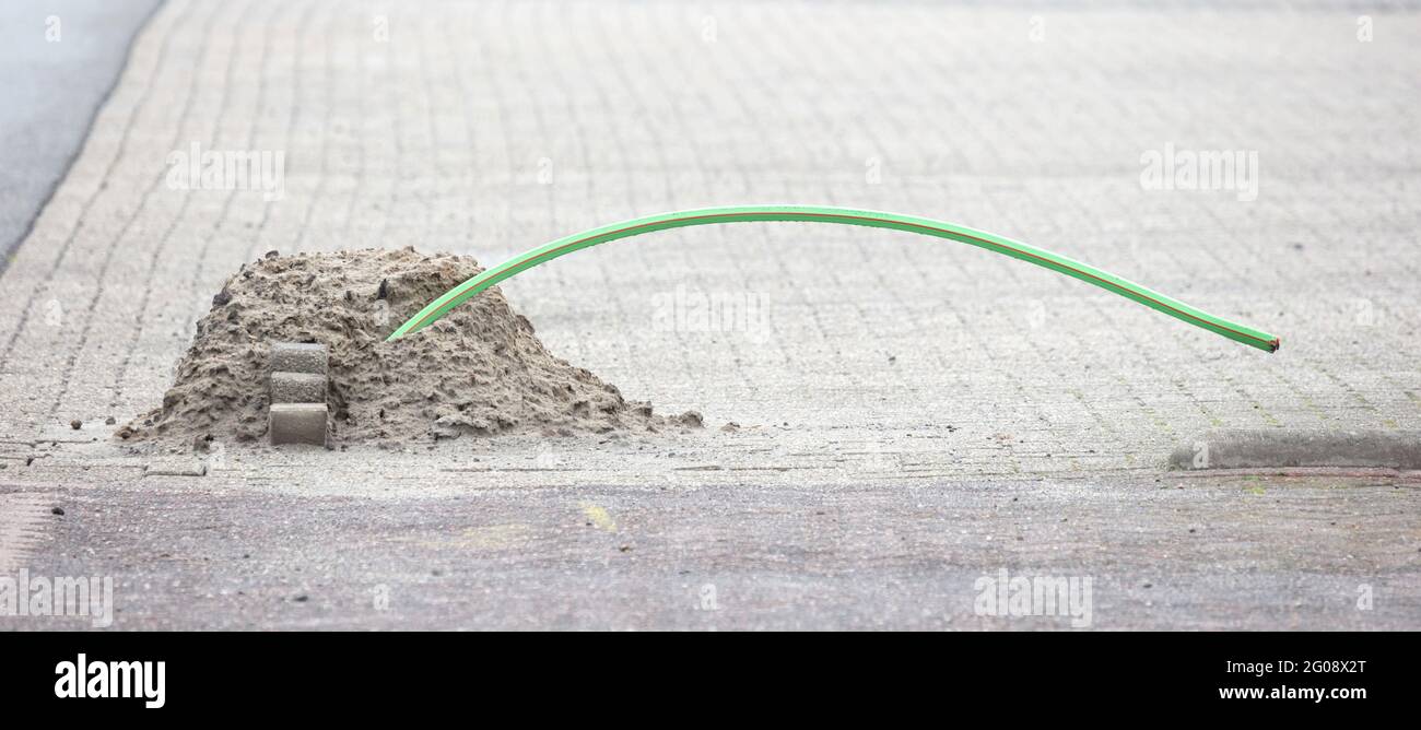 Cable out of the ground, ready to be installed Stock Photo - Alamy