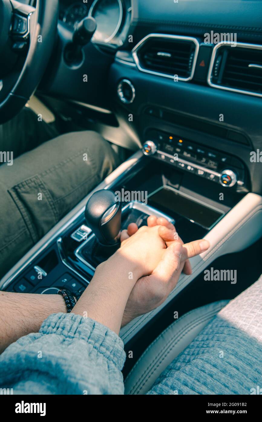 Couple Holding Hands In The Car