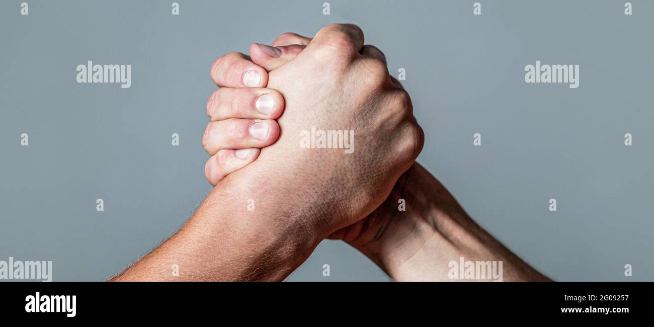 Arms wrestling. Closep up. Friendly handshake, friends greeting ...