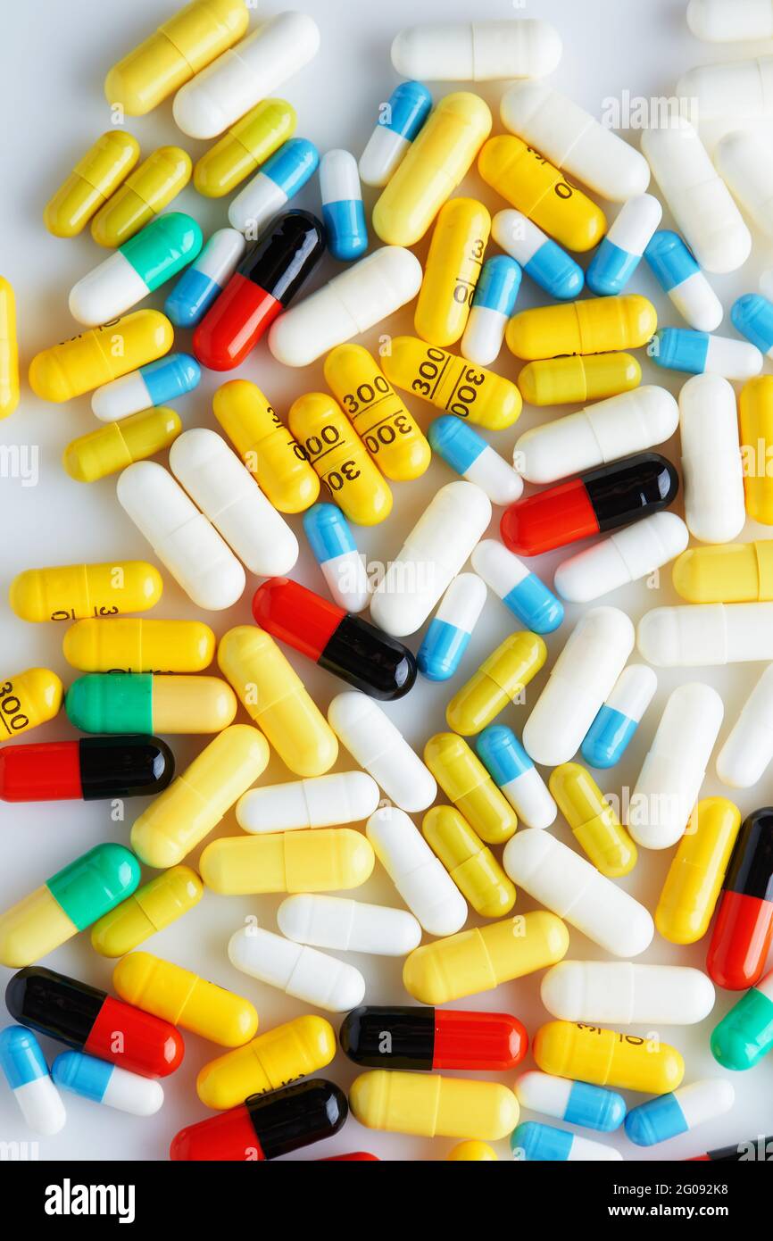 capsules of different colors and sizes against white background Stock ...