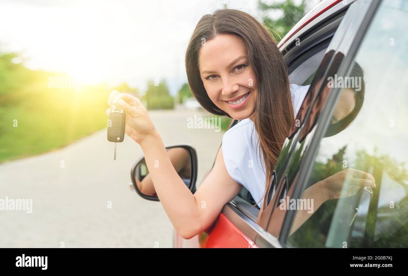 Attractive young woman shows the keys to the car Stock Photo - Alamy