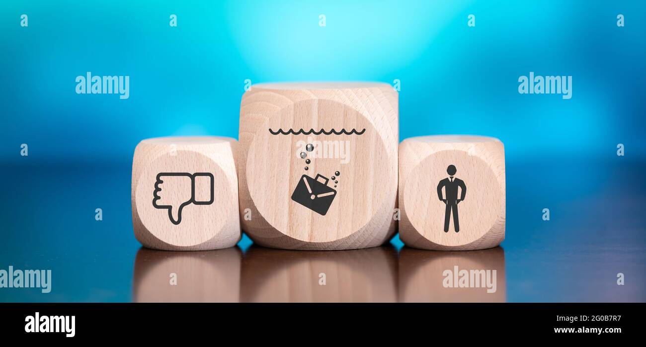 Wooden blocks with symbol of job loss concept on blue background Stock ...