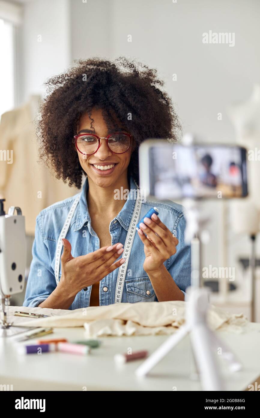 African-American woman shows coil of blue threads shooting new video ...