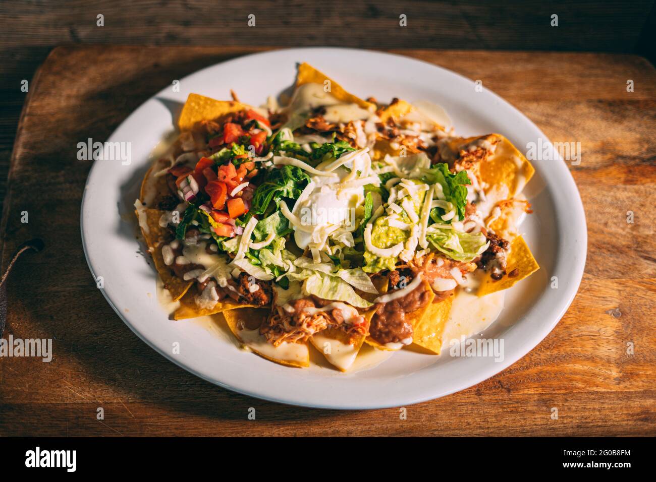 A plate of creamy nachos snack Stock Photo - Alamy