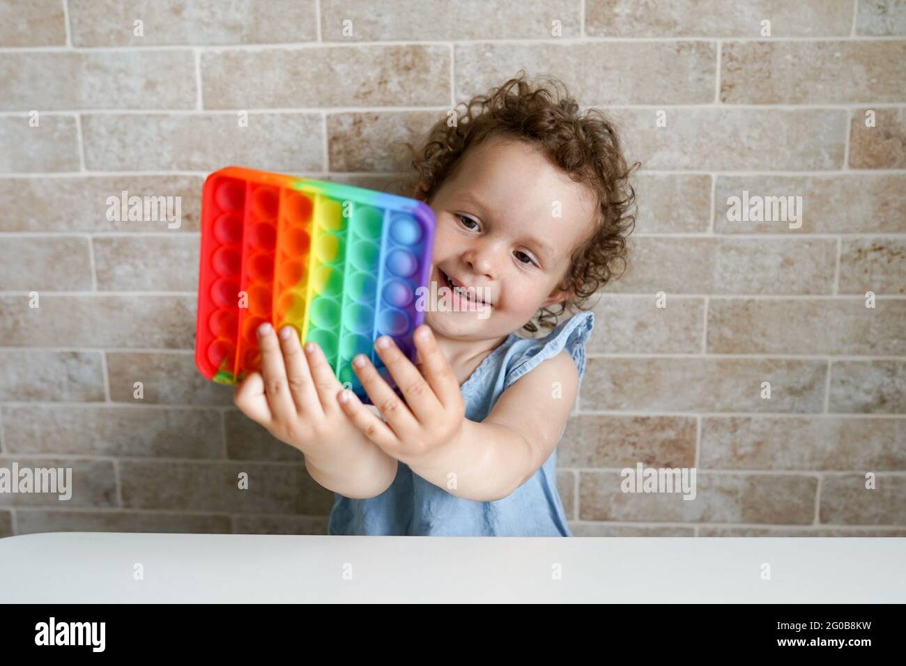 New popular silicone popit toy, baby is playing with it. Development of ...