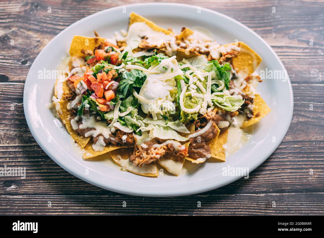 A plate of creamy nachos snack Stock Photo - Alamy