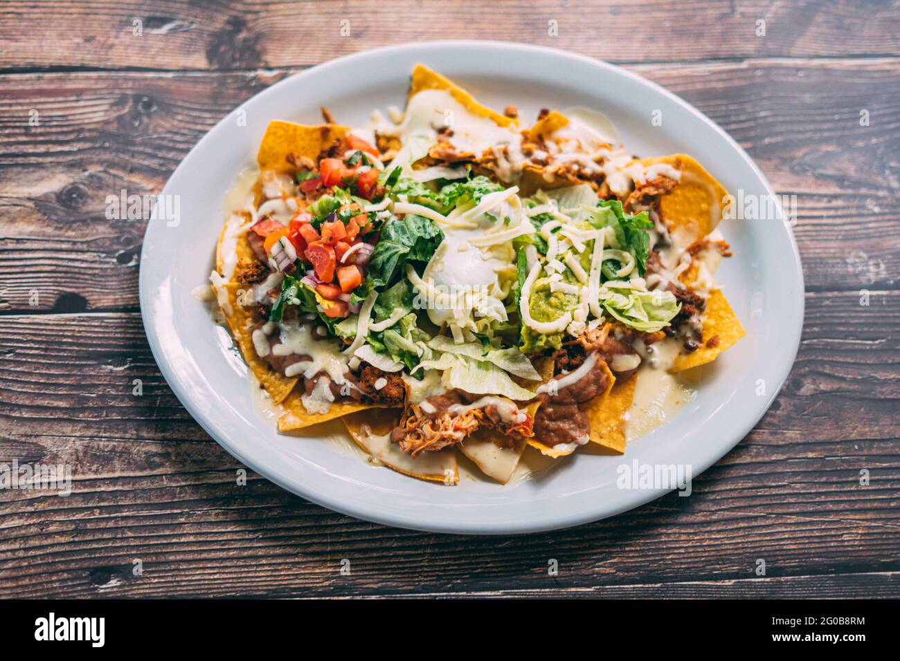 A plate of creamy nachos snack Stock Photo - Alamy