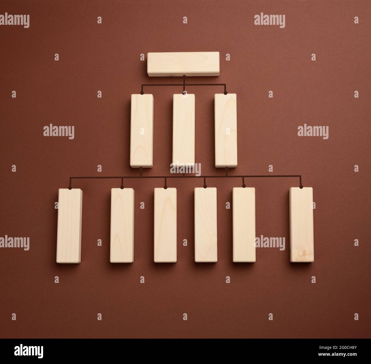 wooden blocks with figures on a brown background, hierarchical ...