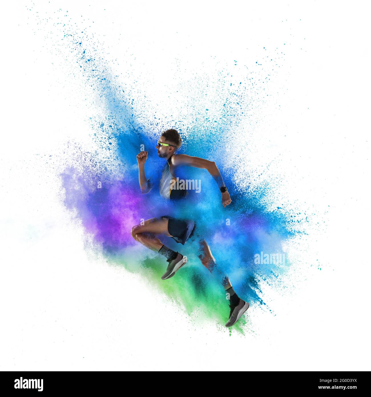 Young sportsman, male athlete running in explosion of colored powder ...