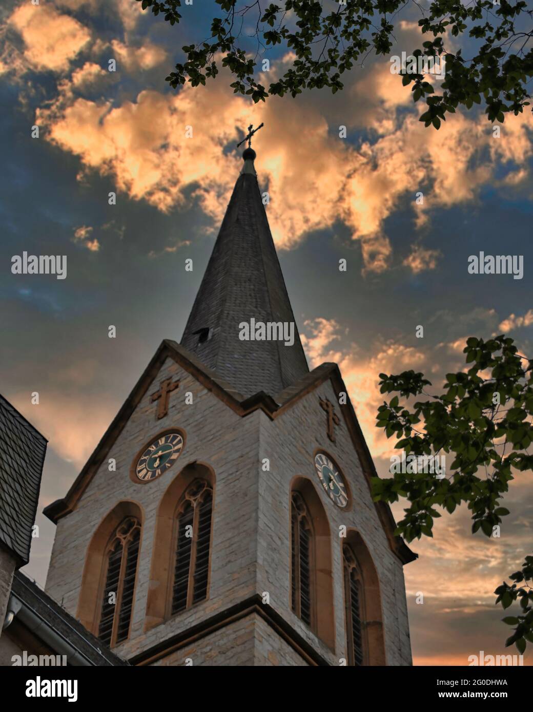 Church tower taken from below at sunset Stock Photo - Alamy