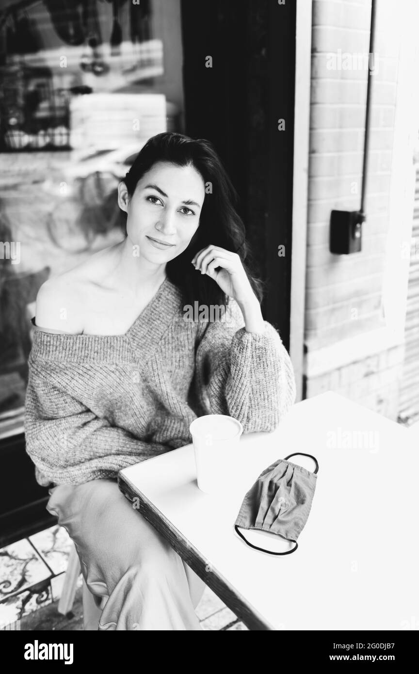Young lady is drinking coffee at the cafe Stock Photo - Alamy