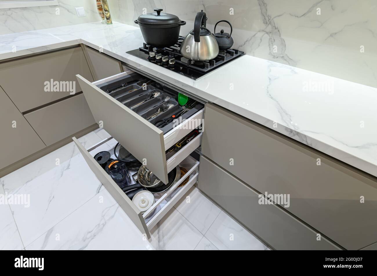 Open drawer with cutlery at modern white woden kitchen in classic style ...