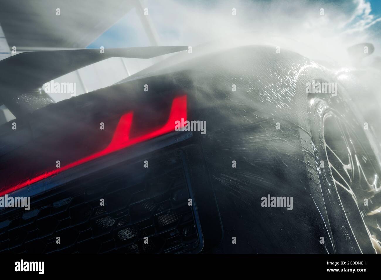 Powerful Pressure Washing of Rear of Performance Car. Car Wash Theme ...