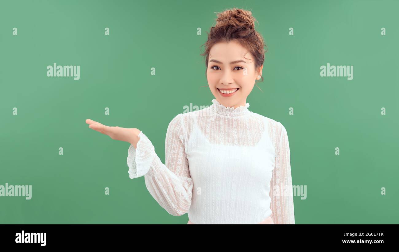 Portrait of positive cheerful woman promoter hold hand present ads ...