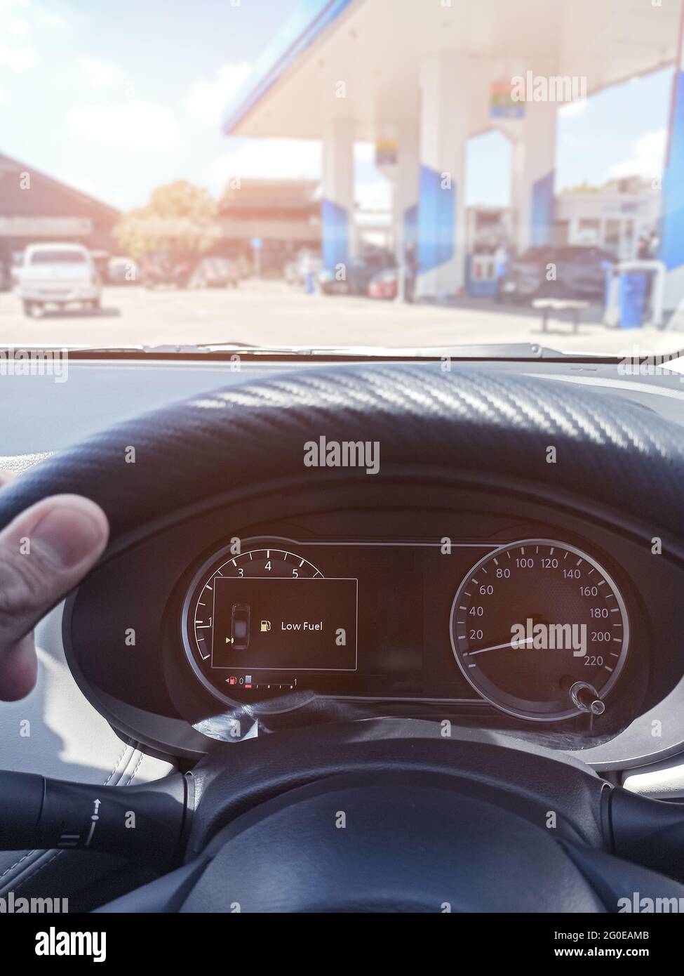 Low fuel gauge warning display in the car causes the driver to drive to ...