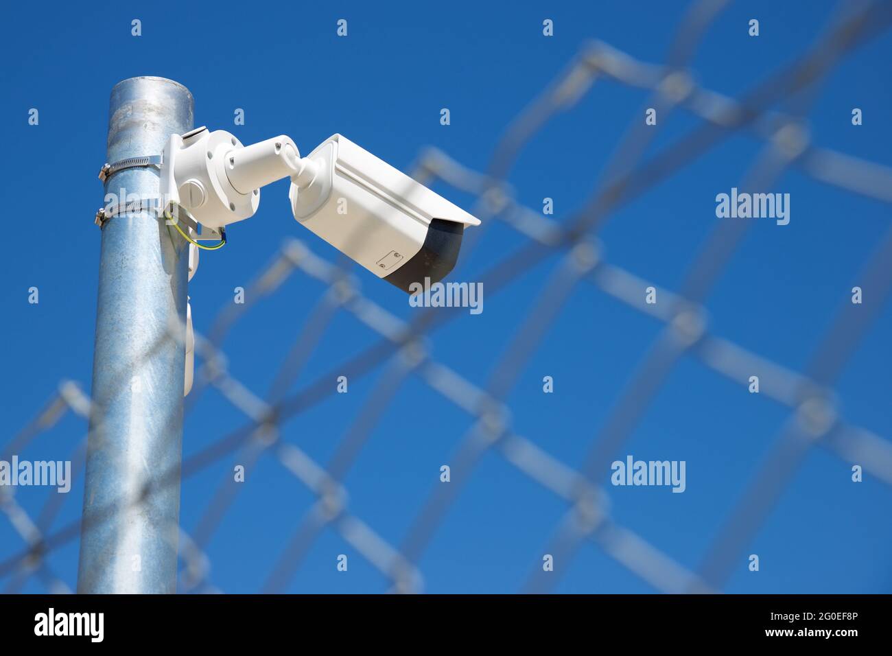 Closeup of a surveillance camera and clear sky Stock Photo - Alamy