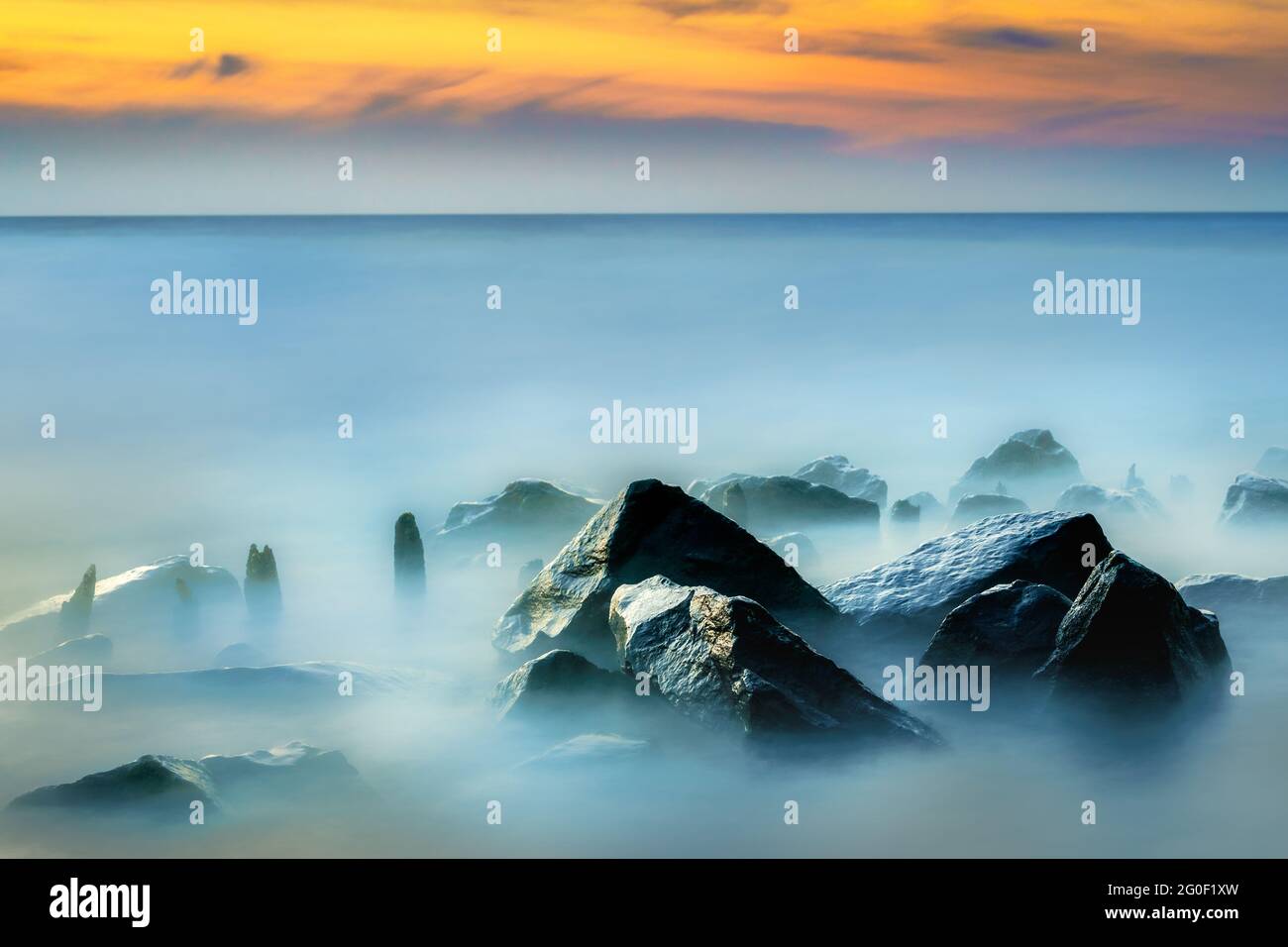 Rocky coast of the sea. Slow shutter speed for smooth water level and ...