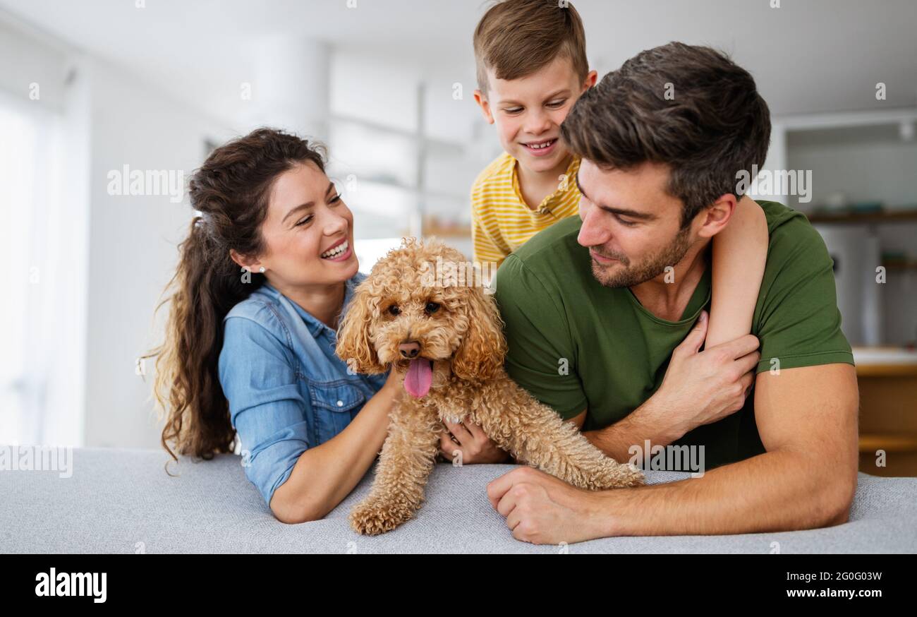 Happy family having fun time, playing together at home with dog Stock ...