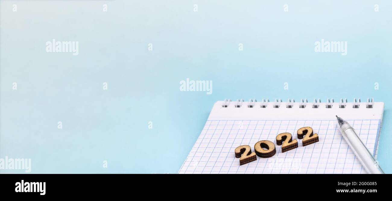Banner 2022 and notepad. Figures 2022 on blue background. Wooden ...
