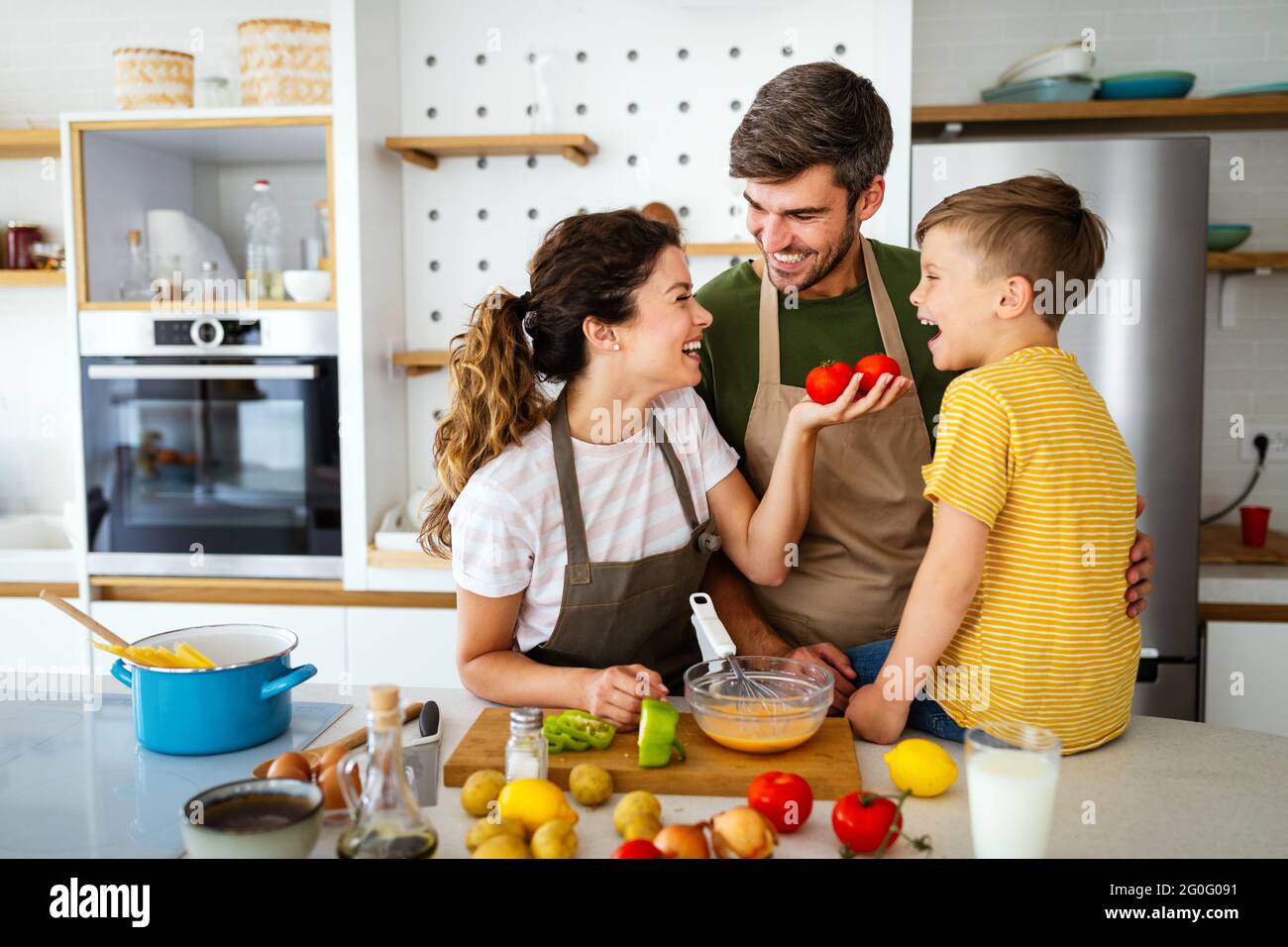 Happy family in the kitchen having fun and cooking together Stock Photo ...