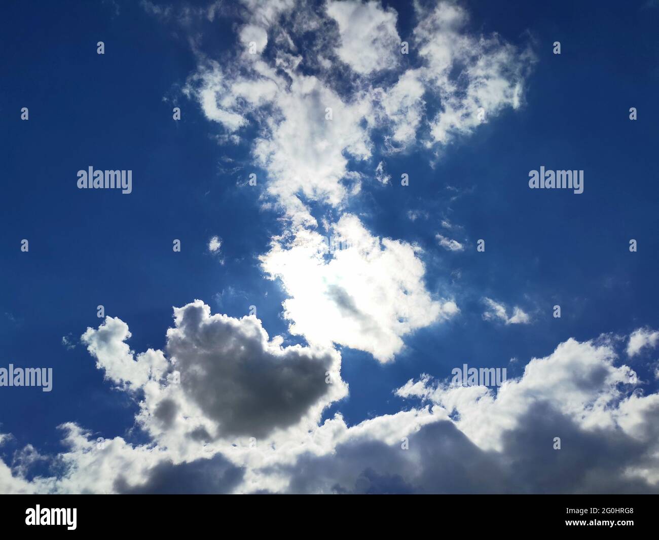 Beautiful bright blue sky with fluffy clouds Stock Photo - Alamy