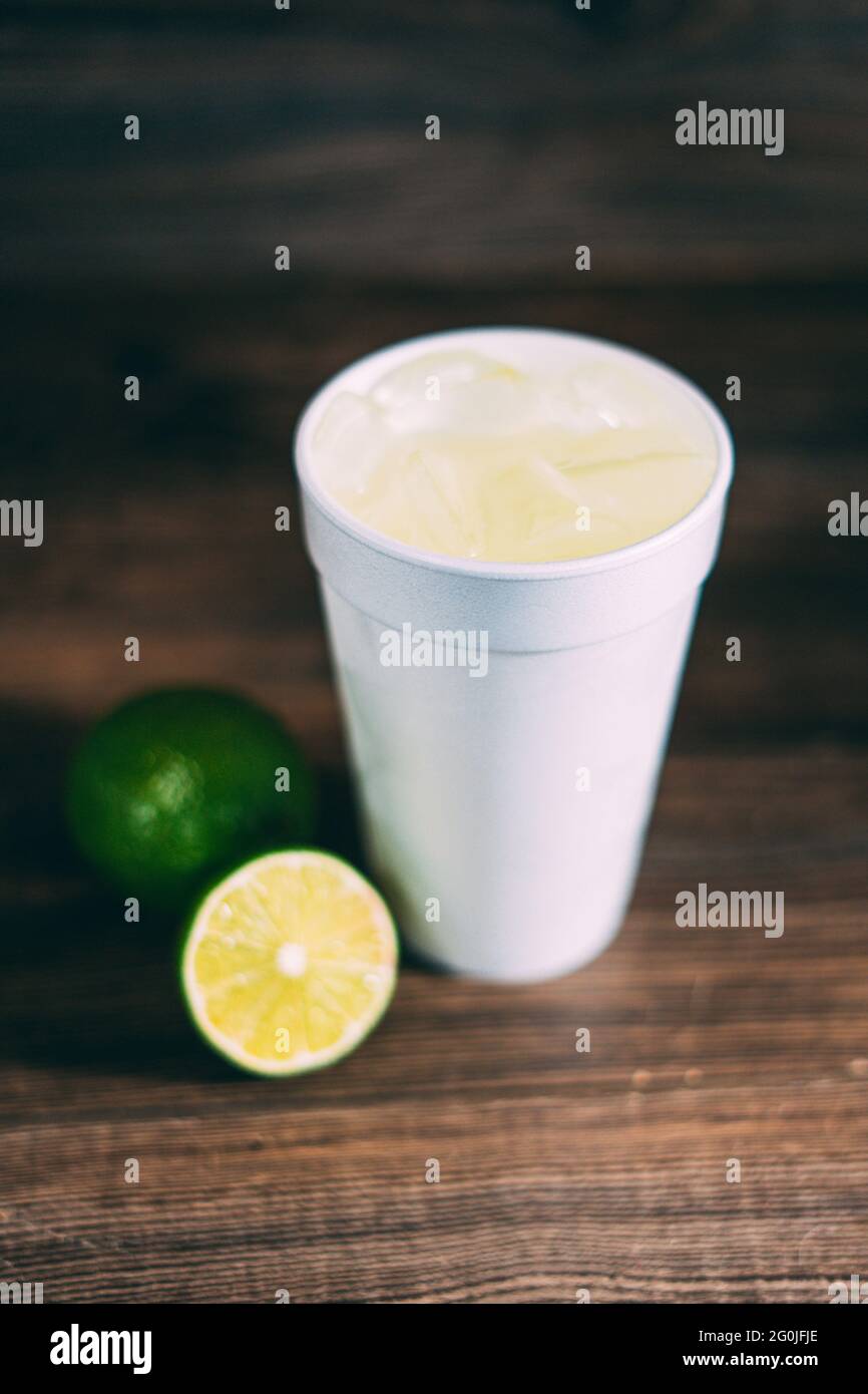 A disposable styrofoam cup and a citrus fruit Stock Photo - Alamy