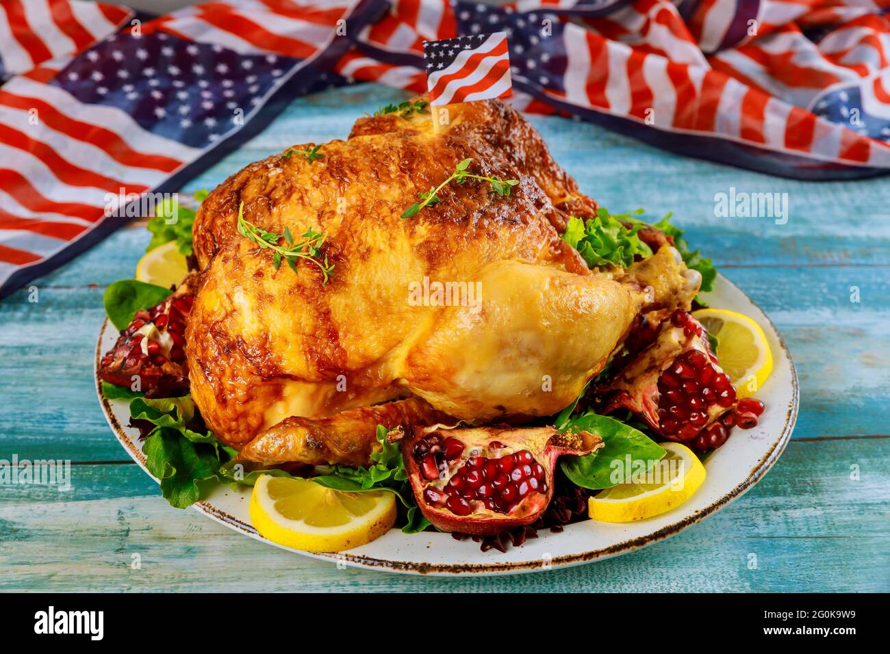 Roasted chicken on plate with american flag Stock Photo - Alamy